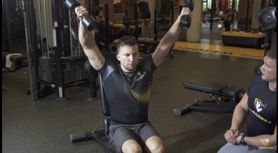 Unoszenie ramion z hantlami na boki siedząc - BudujMase.pl